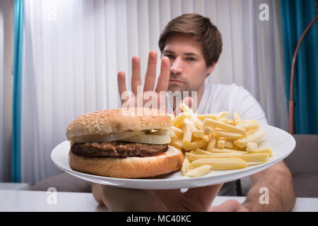 Man Refusing Unhealthy Food Offered By A Person Stock Photo - Alamy