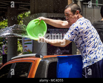 A man throws water with a bucket during the Naval Battle in the working ...