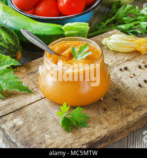 Zucchini caviar in a glass jar, homemade autumn preparations, with ...