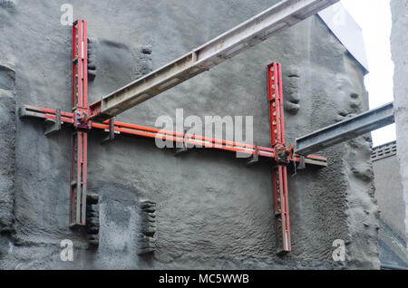 Horizontal beams holding up falling building being restored Stock Photo ...