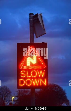 slow down red triangle road sign traffic calming measures blue sky ...