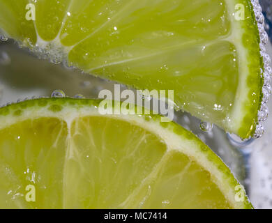 Macro Lime Slices in Sparkling water with bubbles Stock Photo - Alamy