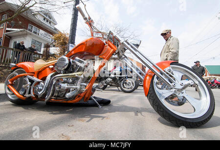 Port Dover, Canada. 13th Apr, 2018. A man shows a motorcycle model ...