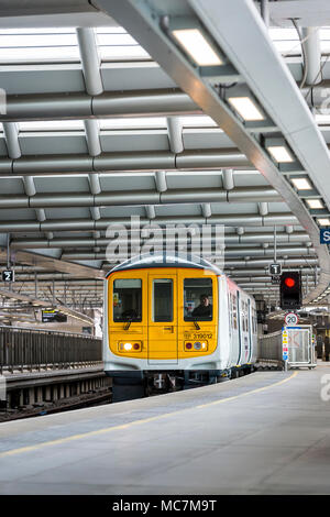 Thameslink class 319 passenger train at a railway station in the UK ...