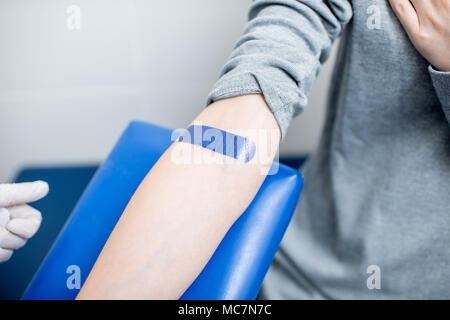 Gluing adhesive plaster after the procedure of blood taking for test in ...