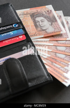 Fanned pound notes and open wallet Stock Photo - Alamy