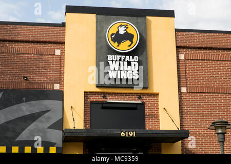 A logo sign outside of a Buffalo Wild Wings restaurant location in ...