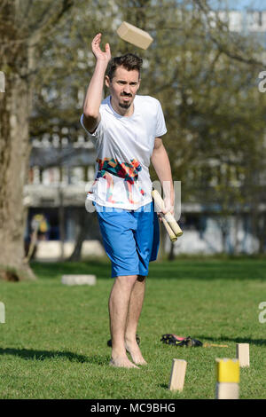 People are seen playing the Kubb lawn game in Mokotowski Park in Warsaw ...