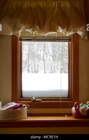 View through the window from cozy wooden cabin to snowy mountains ...