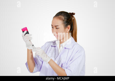 Hand holding syringe with red liquid Stock Photo - Alamy
