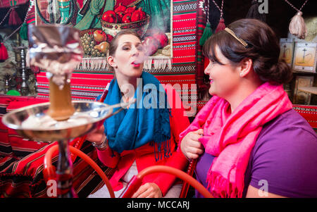 Woman enjoying a shisha pipe in the lounge area, Riad Anayela ...