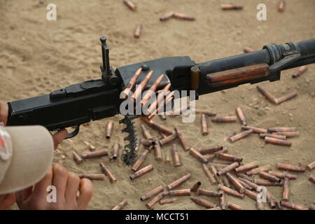The ammunition feeds through the PKC machine gun as an Iraqi soldier ...