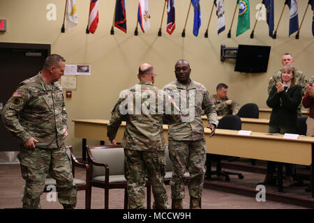 Command Sgt. Major Levi Maynard congratulates incoming commander Maj ...