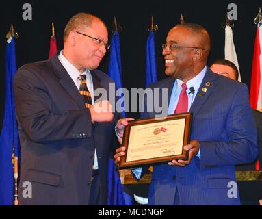 Michael Williams, Army Logistics University president, hands the ...