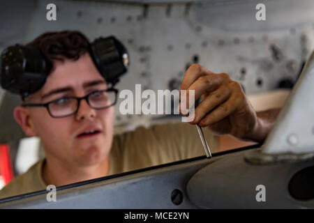 Airman 1st Class Joseph Capshaw, helps in attaching an inert MK-84 ...