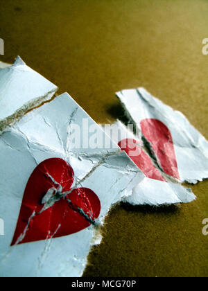 Two of hearts playing card torn in half Stock Photo - Alamy