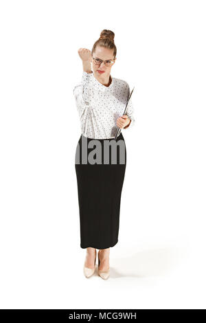 An angry young female teacher holding ruler against chalkboard Stock ...