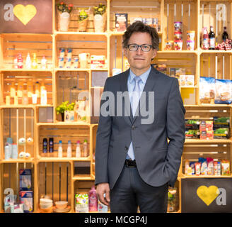 Markus Mosa, CEO of Edeka AG, poses in front of the company logo after ...