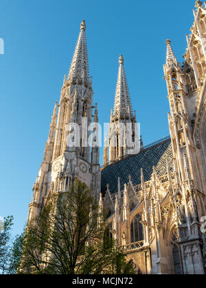 An old detailed Vienna church tower with copper roof reflects in the ...
