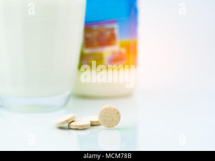 Milk tablets jar on the table, depth Stock Photo - Alamy