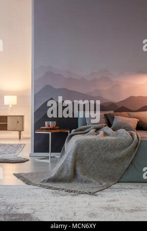 Cozy bedroom interior with grey pillows, white linens, wooden headboard ...