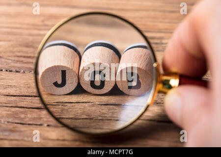 Wooden blocks with symbol of job search concept on blue background ...