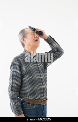 Senior man wiping off sweat Stock Photo - Alamy