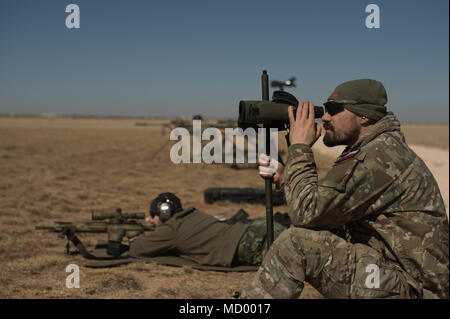 A NATO sniper trains on firing at long distances with sniper rifle ...