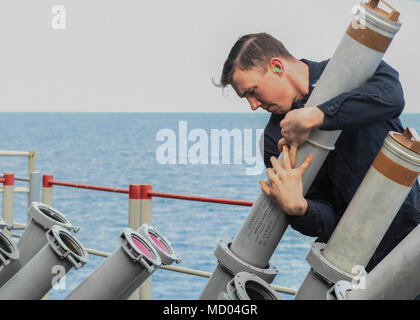 Cryptologic Technician loads an MK-214 seduction chaff canister into a ...