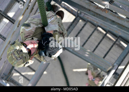 A Royal Marine Commando fast ropes from a Royal Air Force ...
