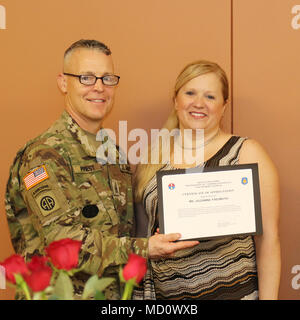 Division Command Sergeant Major Todd Sims congratulates and gives a ...