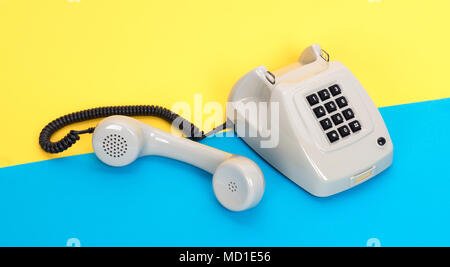 Vintage grey telephone with a colorful background Stock Photo - Alamy