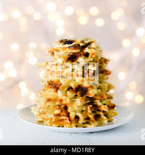 Traditional cake Shakotis, Sakotis on white plate, festive background ...
