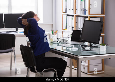 Close-up Of A Young Businesswoman Stretching Her Arms At Workplace ...