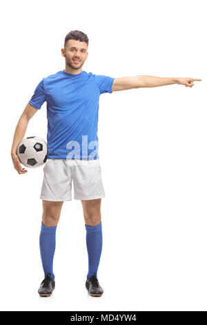 Smiling sportsman with football pointing with finger at camera isolated ...