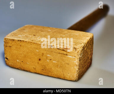 A hammer from a tree lies on an isolated background. The hammer was ...