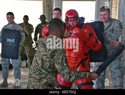 A member of the Royal Bahamas Defence Force clears the room during ...
