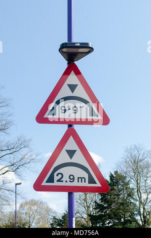 Maximum height warning sign in English and Arabic against a blue sky ...