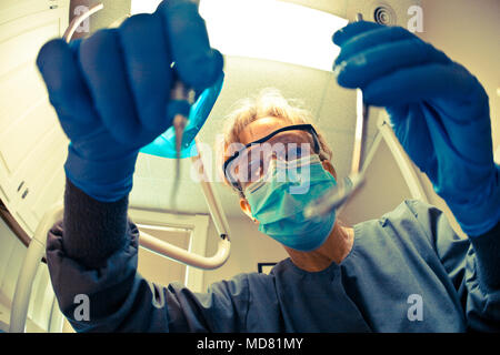 Female dentist with dental tools on blue background. World Dentist Day ...