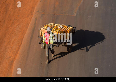 Man pulling a handcart which is know as a 'mkokoteni' Swahili, loaded ...