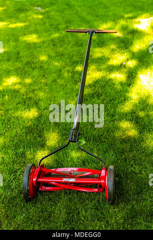 Old Hand push lawn mover, with spindle blade for cutting grass. Showing ...
