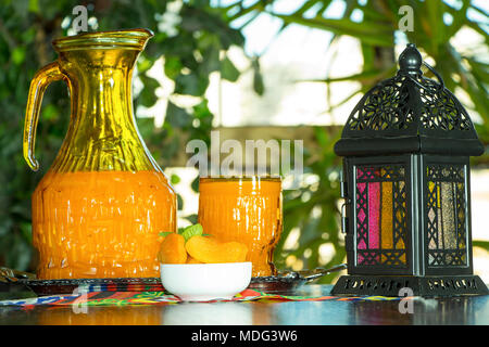 Table with Qamar El Din ( Apricots Juice) and Ramadan fanous (lantern ...