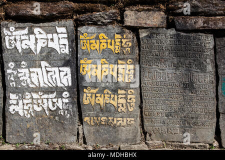Tibetan script on rocks in the Nepalese Himalayas; Nepal Stock Photo ...