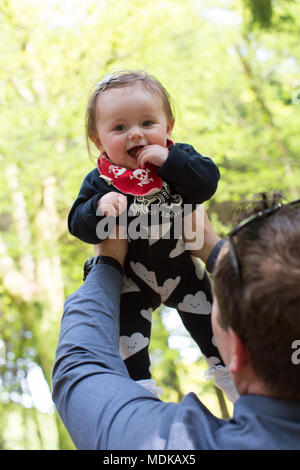 man dad having quality time with their kid son boy six year old on arms ...