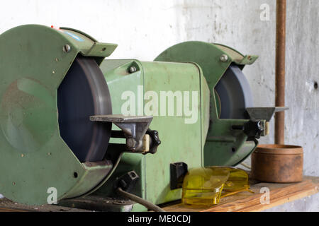 Bench grinder for locksmith's work on a wooden table. Locksmith ...