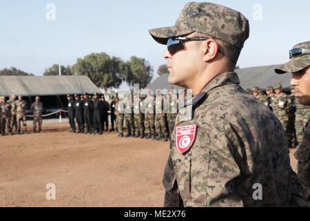 A soldier from the Tunisian Special Forces Group begins taking off his ...
