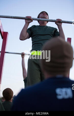Marine recruits perform pull up exercises during basic training at the ...