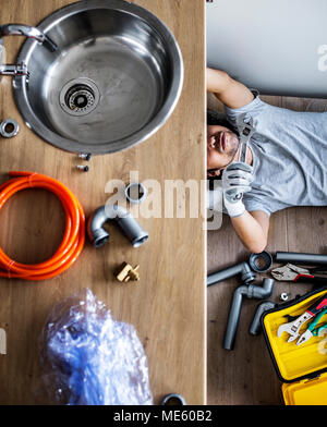Man fixing kitchen sink Stock Photo - Alamy