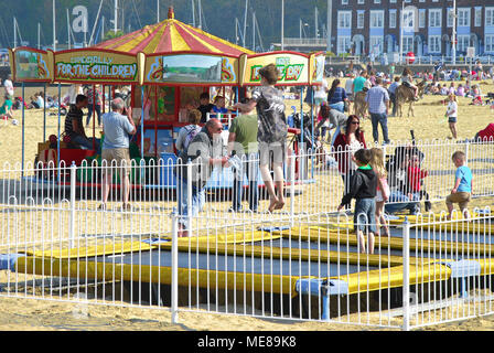 Weymouth Pavilion, beach and fairground ride on a warm sunny day for ...