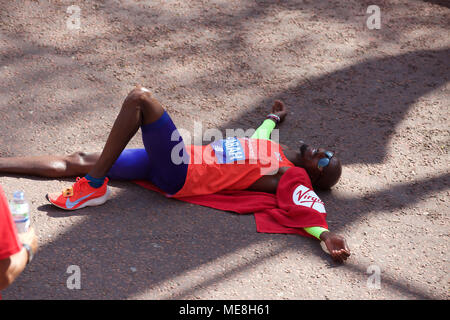 A runner collapses at the finish line of the Virgin money London ...
